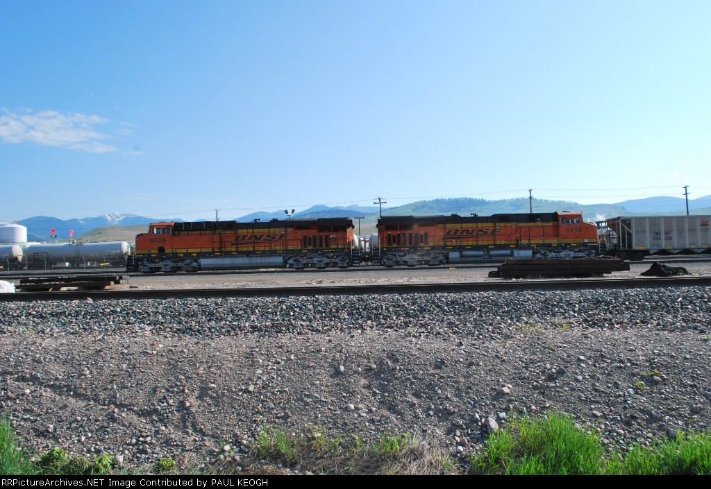 Side shot of BNSF 6415 and BNSF 6409 as they roll into the MRL Yard as rear DPU's on a empty ...
